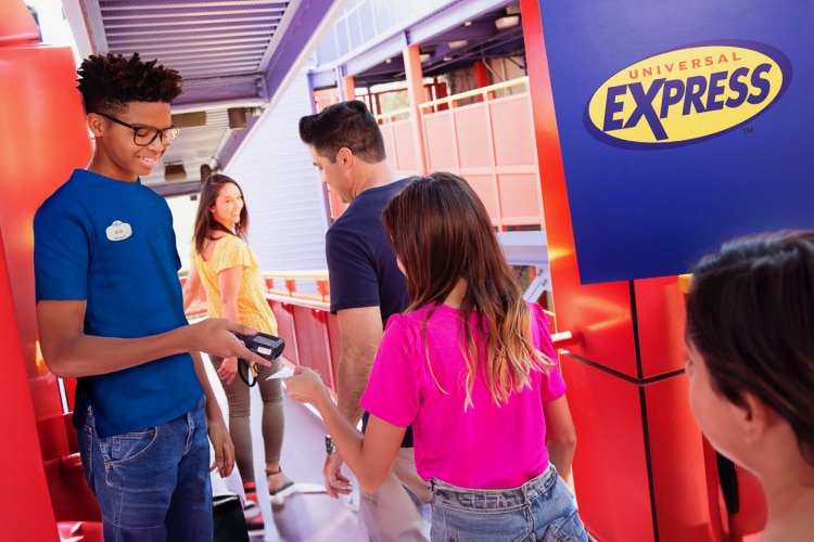 A Universal Team Member scanning in guests through a Universal Express ...